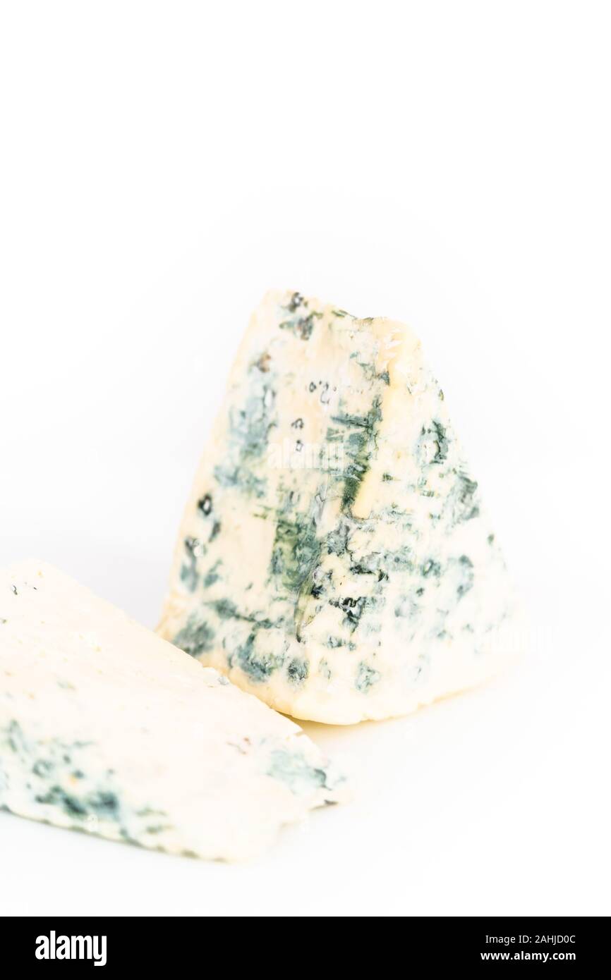 Large slice of blue cheese on a white background Stock Photo - Alamy