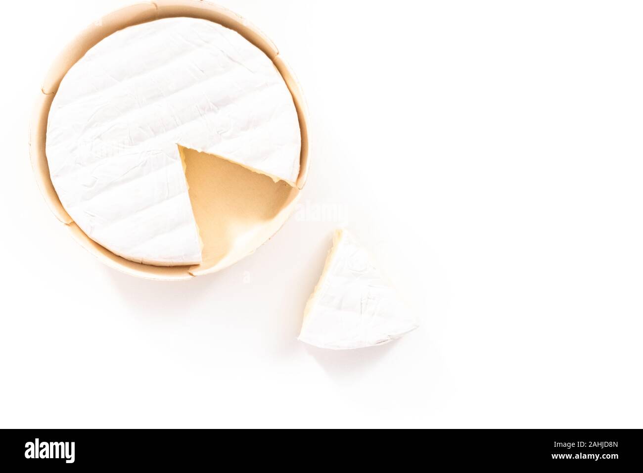 Large slice of brie cheese on a white background Stock Photo - Alamy