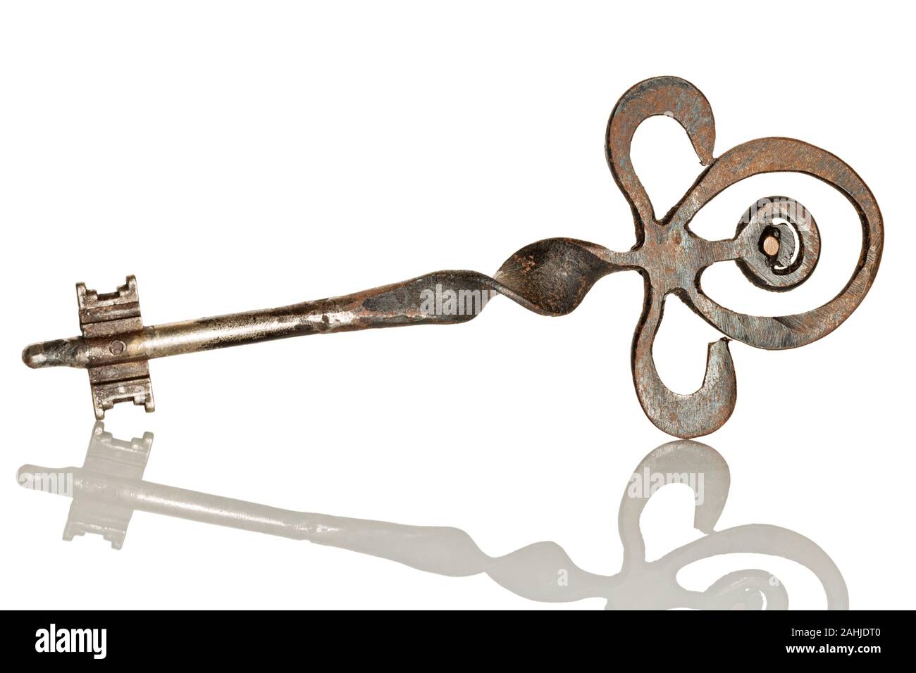 Single old metal key on white background with reflection, isolated ...