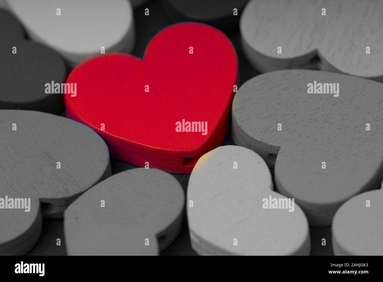Single red heart on many black and white hearts Stock Photo - Alamy