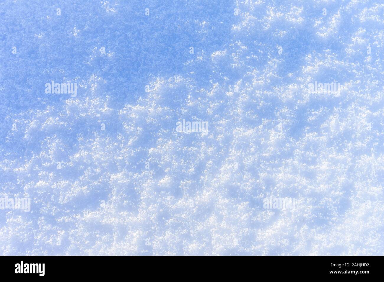 Snow texture at sunny winter day. Abstract background with shadows and ...