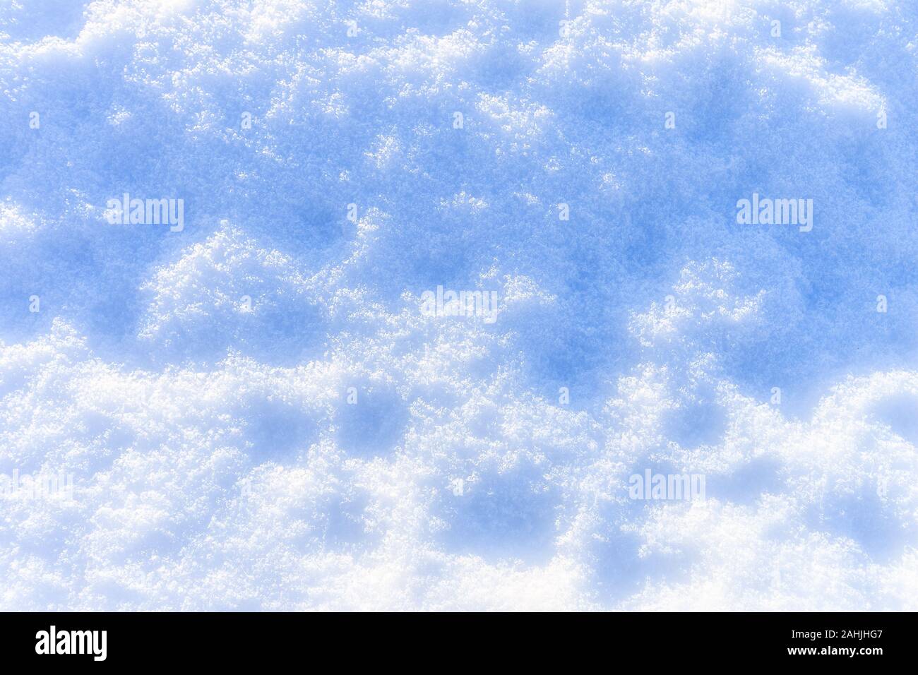 Snow texture at sunny winter day. Abstract background with shadows and ...