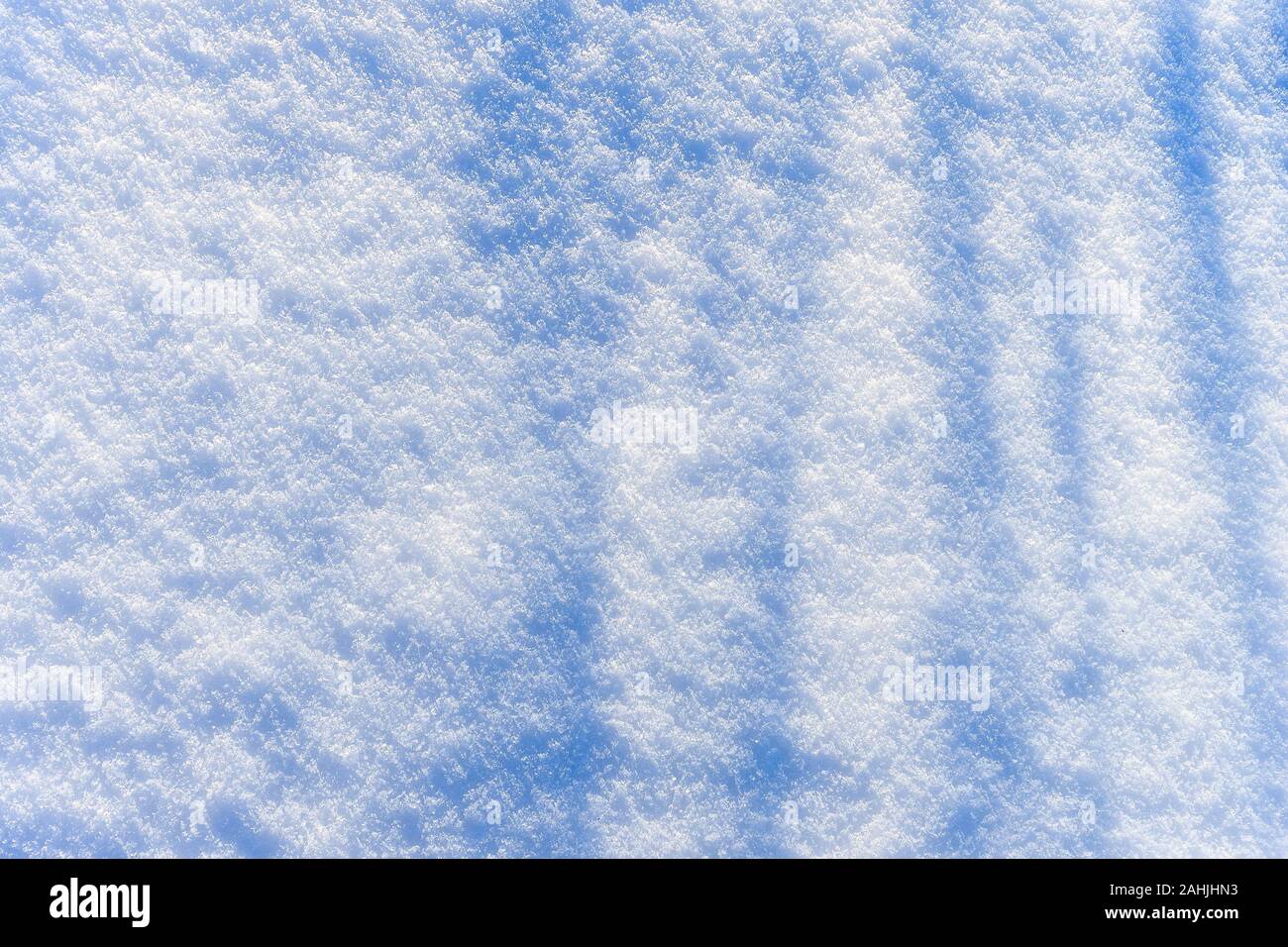Snow texture at sunny winter day. Abstract background with shadows and ...