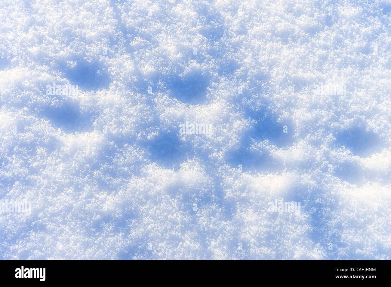 Snow texture at sunny winter day. Abstract background with shadows and ...