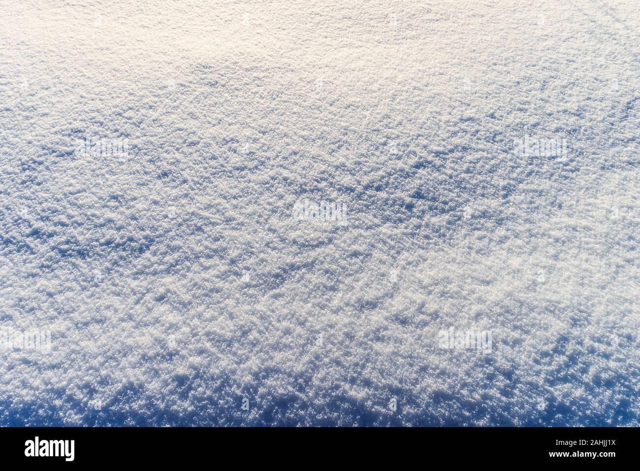 Snow texture at sunny winter day. Abstract background with shadows and ...