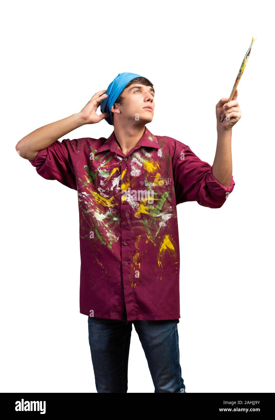 Young male painter artist holding paintbrush. Portrait of painter in ...