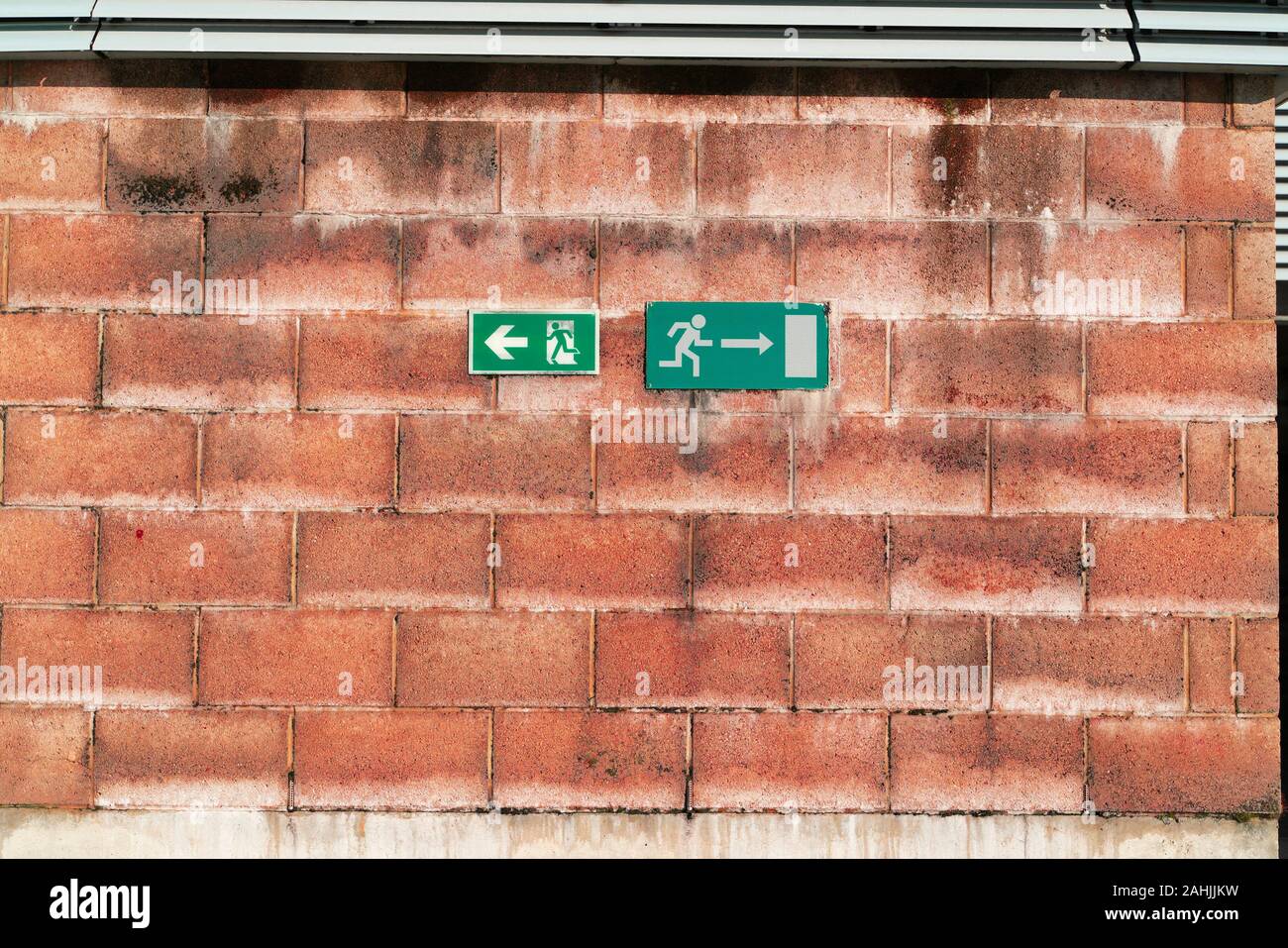 Pink Wall, Green Signs Stock Photo - Alamy