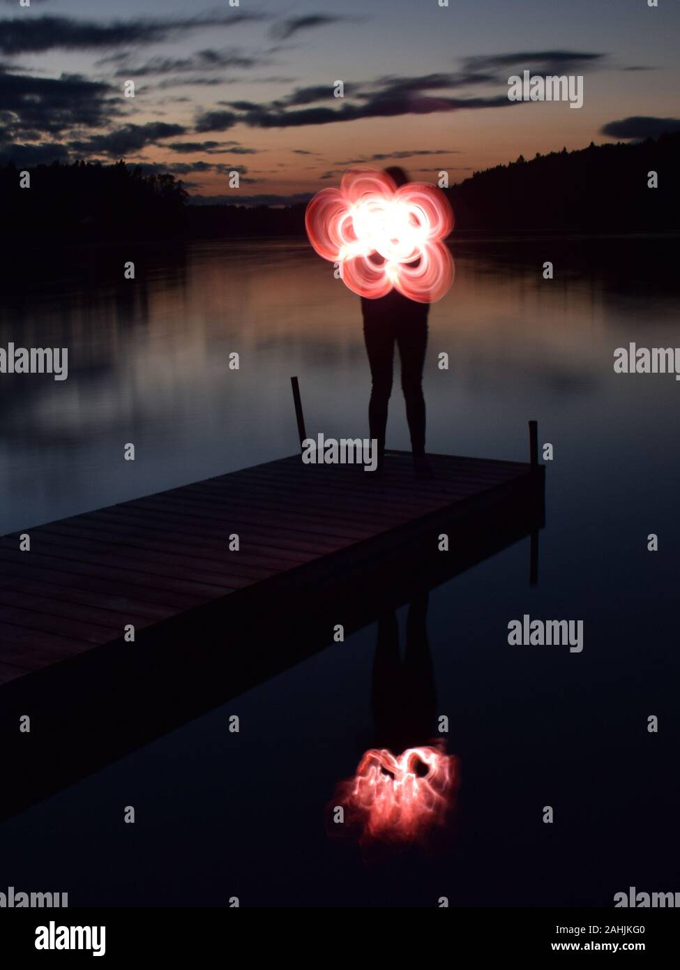 light painting, long exposure, red and white flower on a black ...