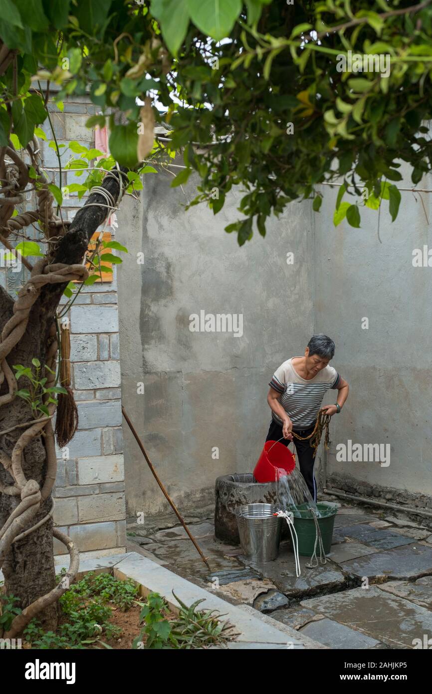 Local resident fetches water from an ancient well from The Ming dynasty ...
