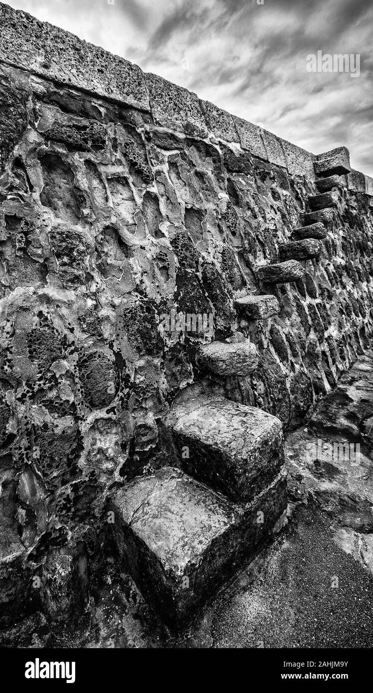 Ancient steps inset into The Cobb harbour wall Stock Photo - Alamy