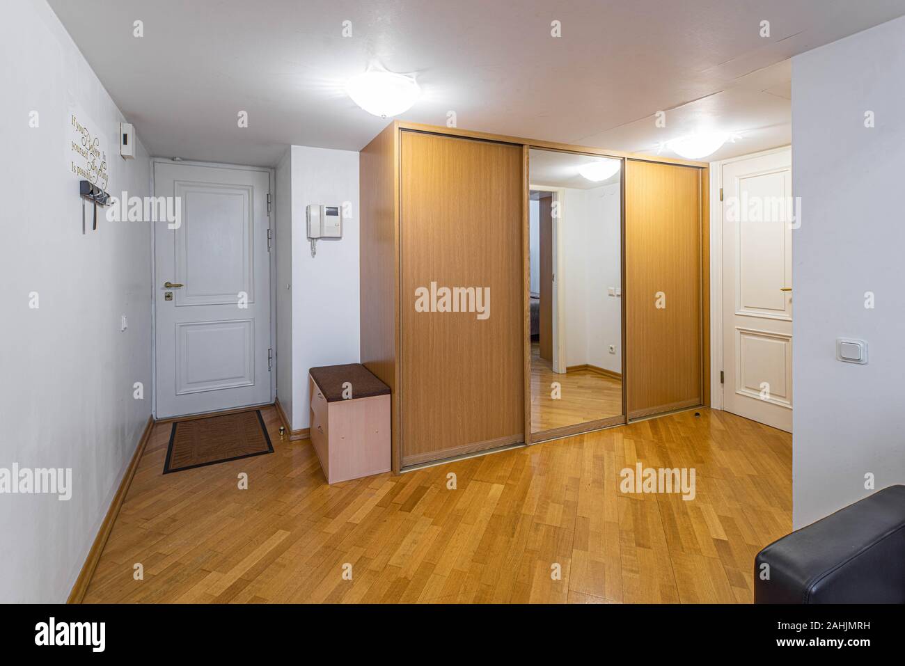 Entrance hall in studio apartment. Wardrobe with mirror. Light interior ...