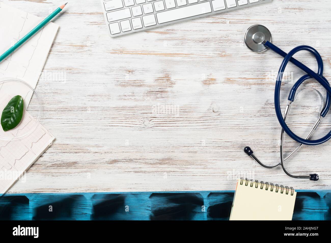 Doctors desktop with medical supplies. Computer keyboard, x-ray image ...