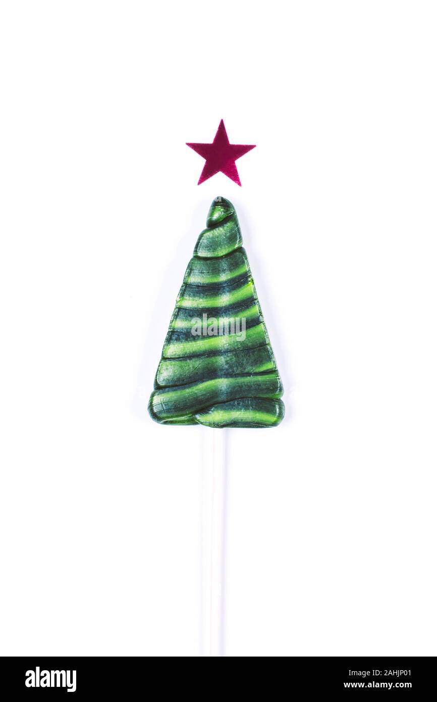 Christmas tree with red star shaped lollipop on white background Stock ...