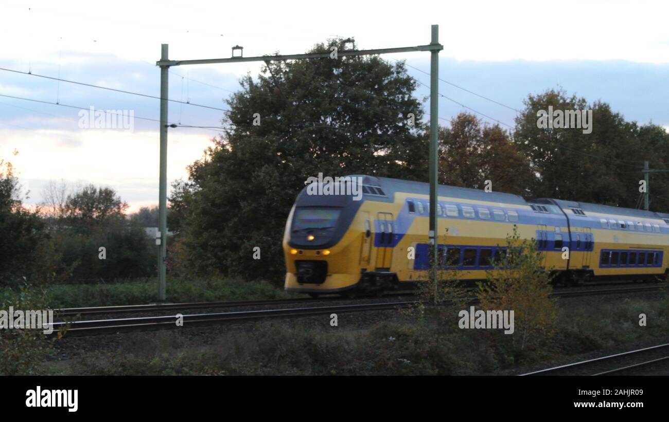 A NS VIRM passenger train passing under a pylon at Blerick, Netherlands ...