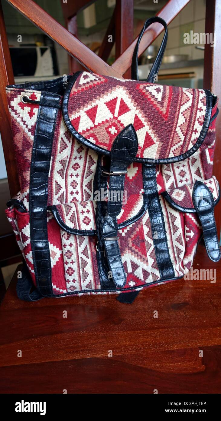 A cloth backpack with colorful decorations and black suspenders Stock ...