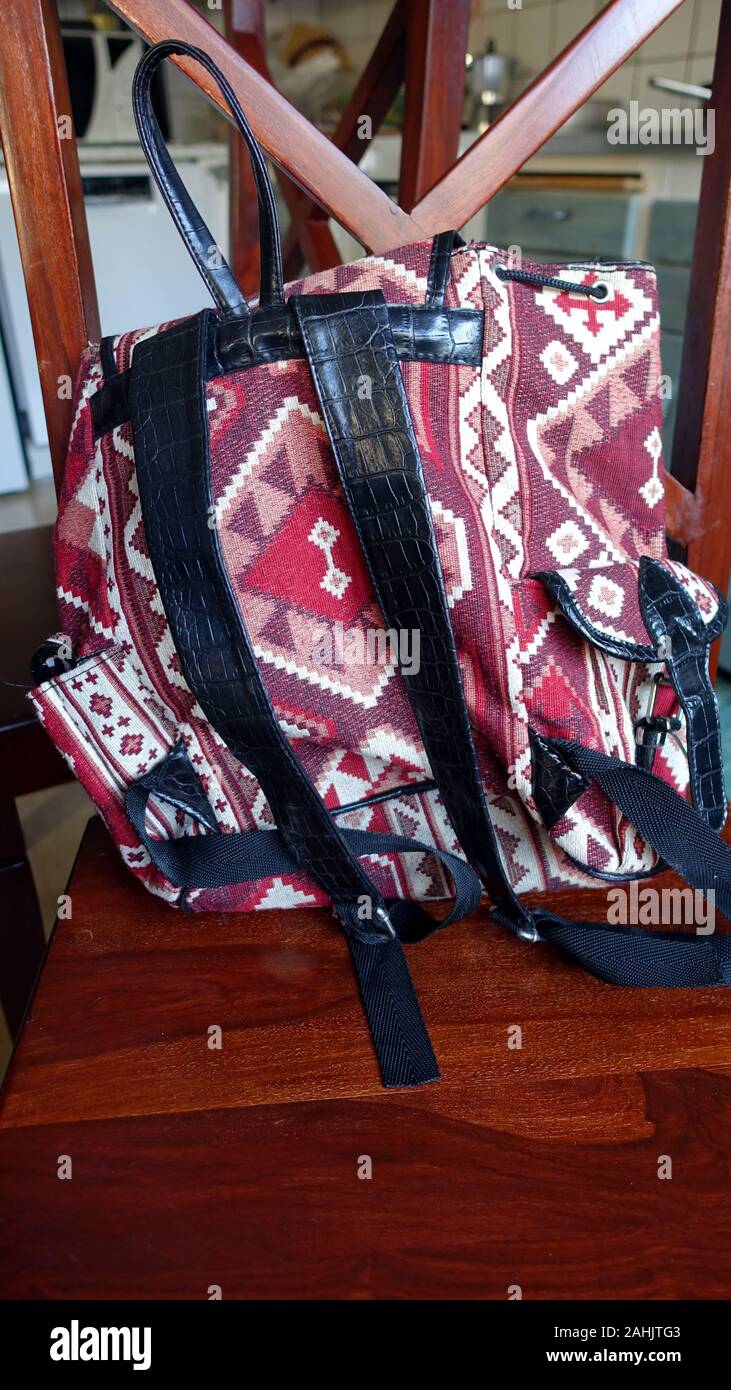 A cloth backpack with colorful decorations and black suspenders Stock ...