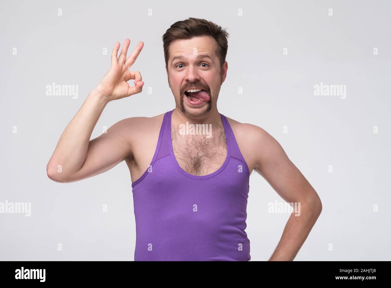 Funny young caucasian sportsman making OK sign Stock Photo - Alamy
