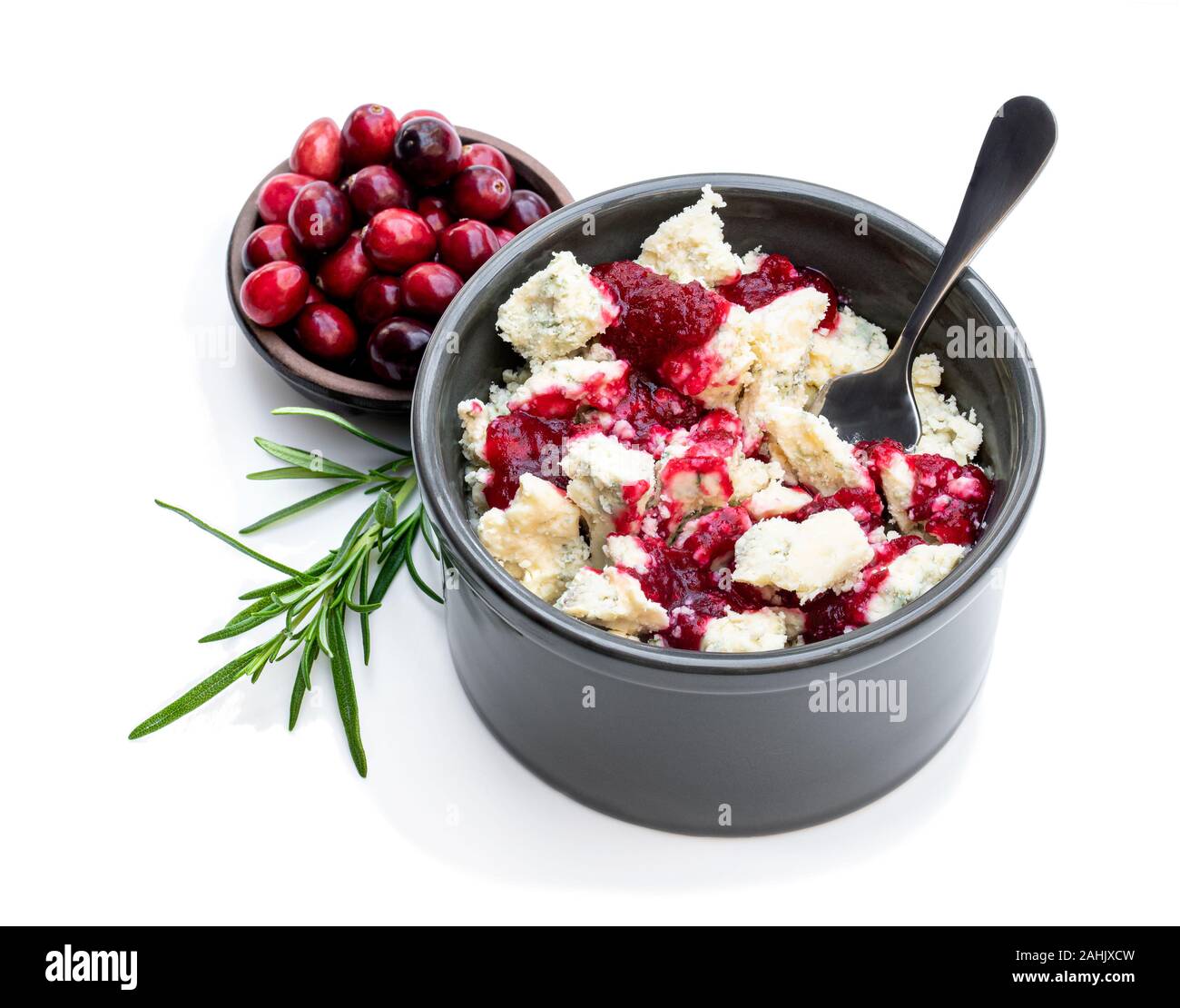 Potted aged Blue stilton cheese with cranberry sauce isolated on white ...