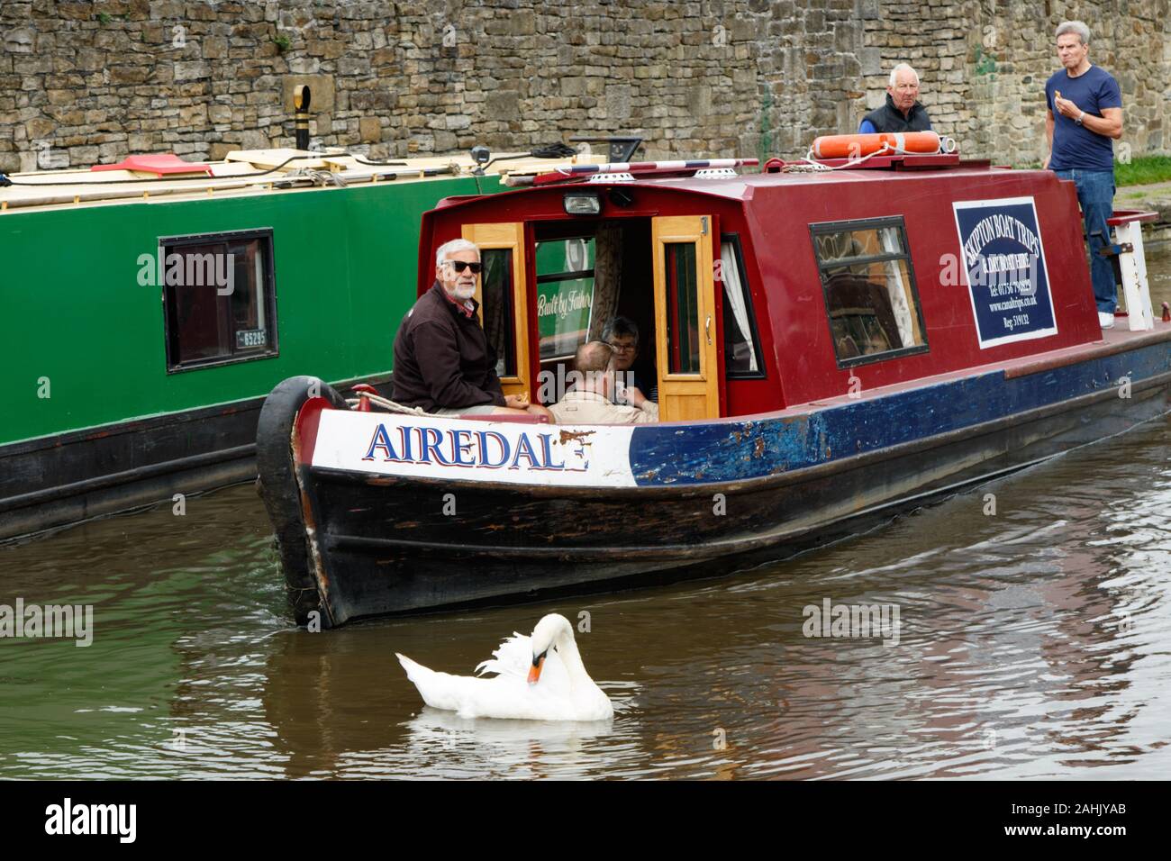 Barge with male passengers on board travelling down the Leeds and ...
