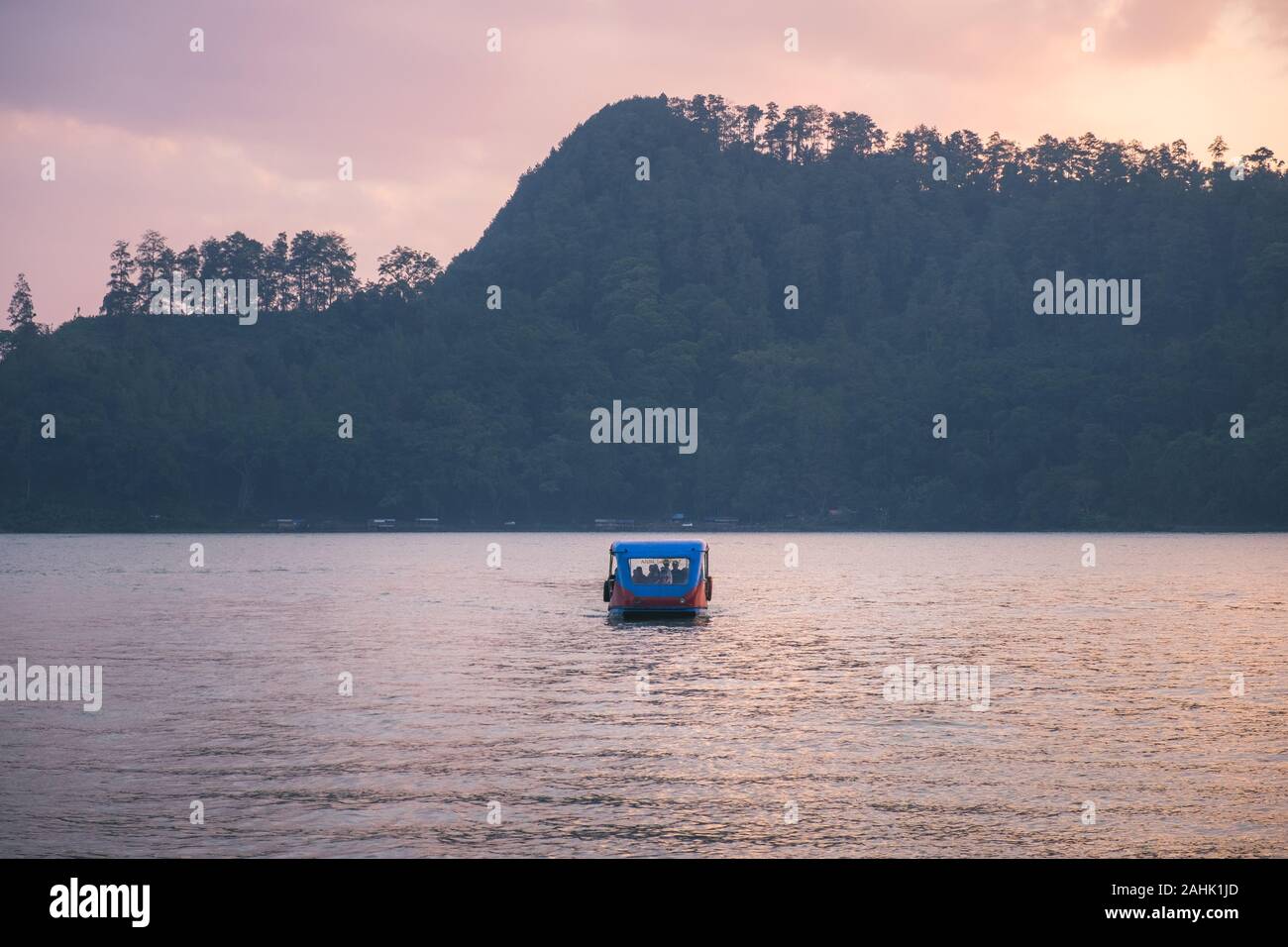 Tourist boat on Ngebel Lake at sunset, Ponorogo, East Java, Indonesia ...