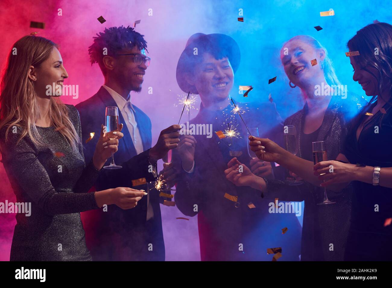 Multi-ethnic group of elegant young people enjoying Christmas party in ...