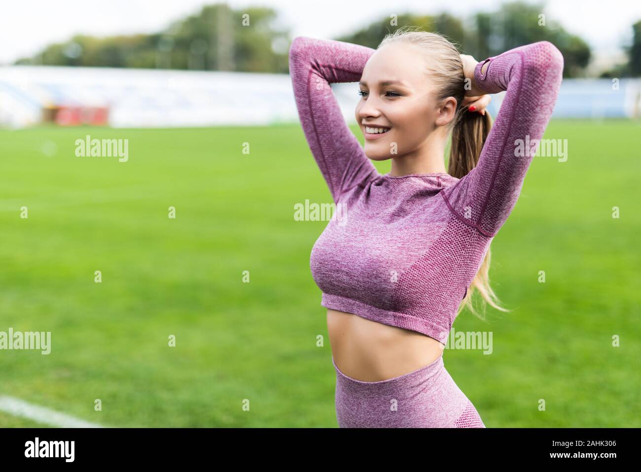Sport woman athlete bind ponytail on stadium - back view Stock Photo ...