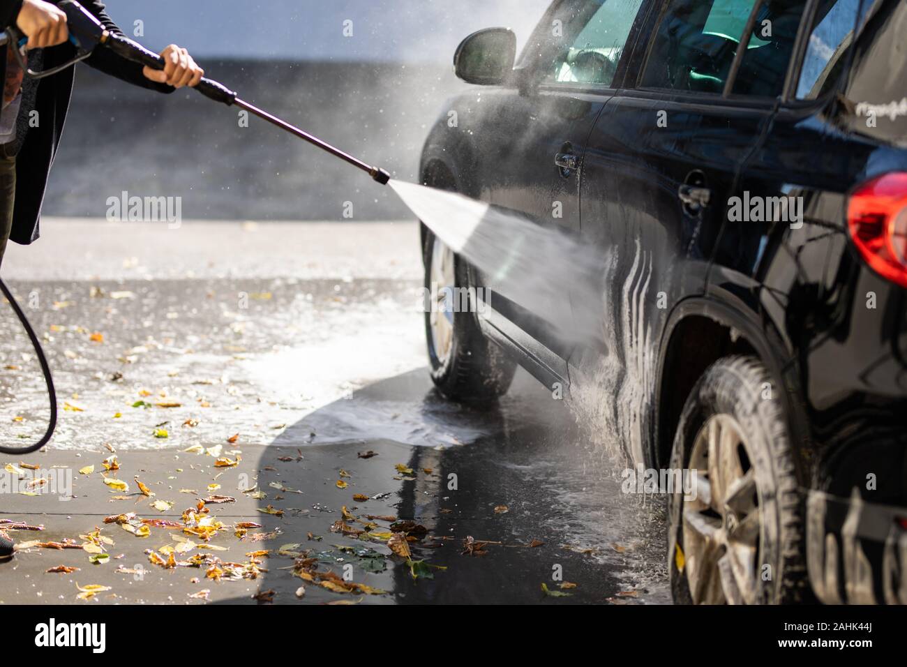 Man washing his car in a self-service car wash station Stock Photo - Alamy