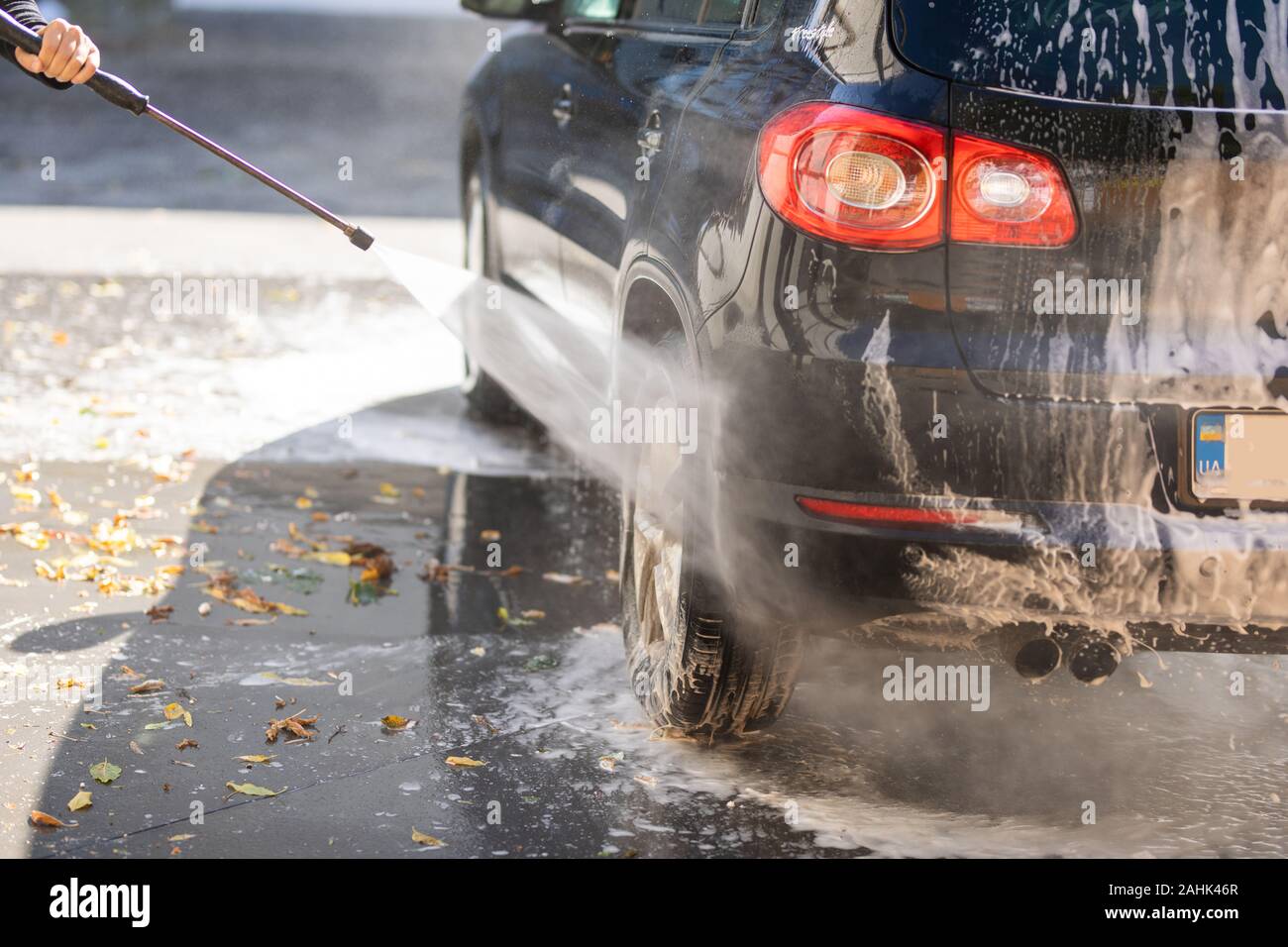 Car washing. Cleaning car using high pressure water Stock Photo - Alamy