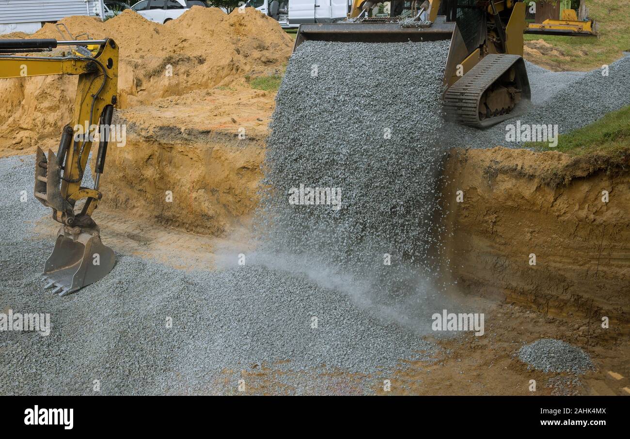 Loading of stone construction of foundation excavator works in a gravel ...