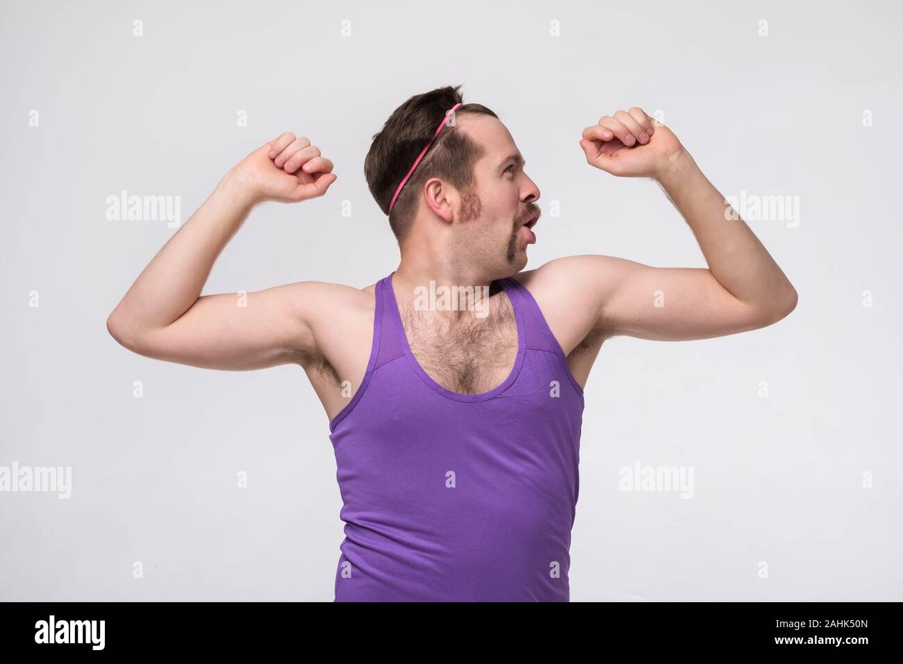 Funny man with mustache showing his muscles over gray background Stock ...