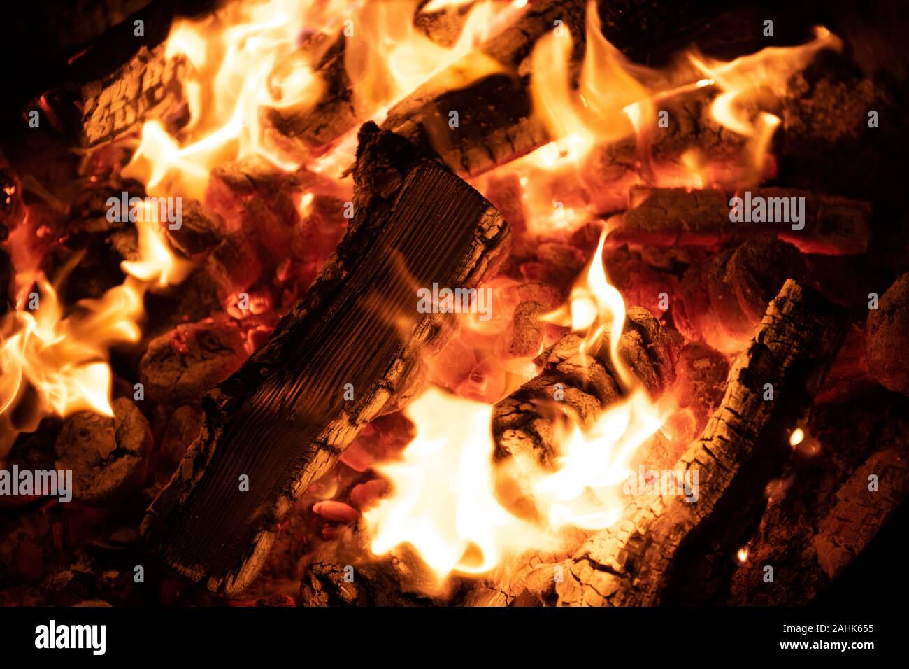 A glowing camp fire providing comfort and light during a cool summer ...