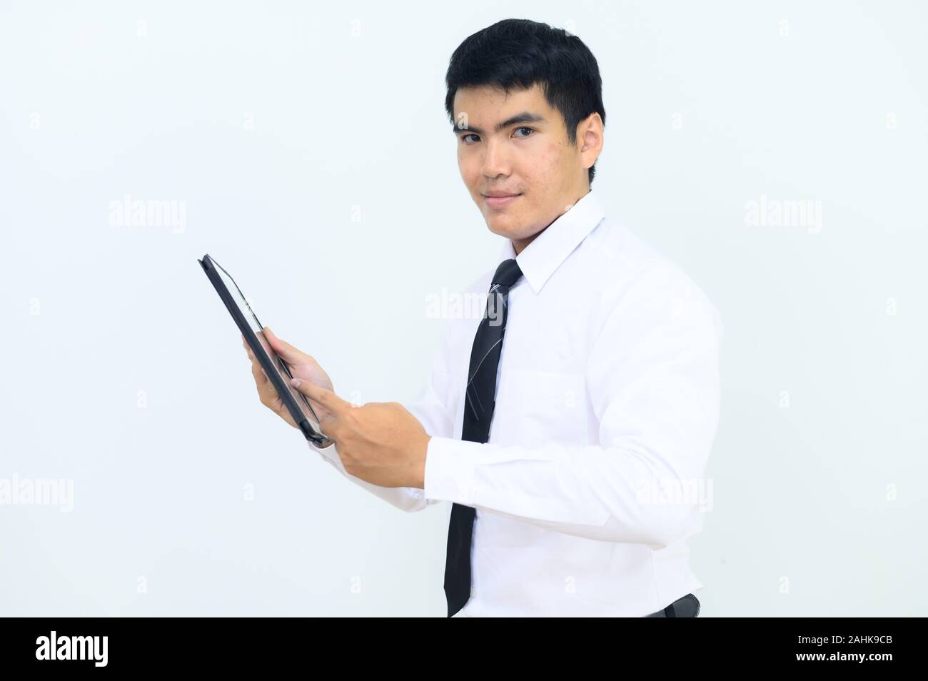 Young South East Asian businessman and his tablet in white background ...