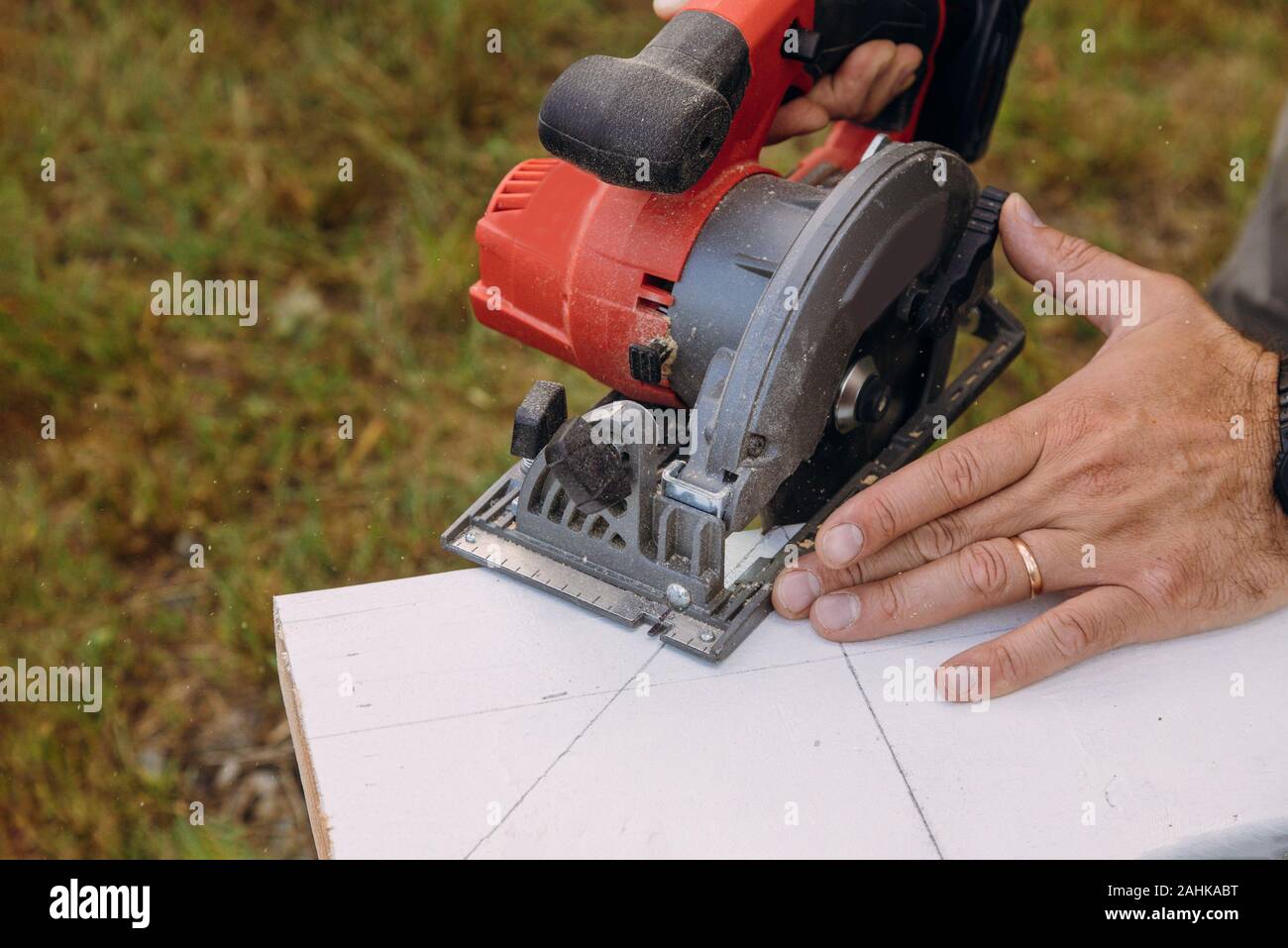 Carpenter using hands cutting wood with electric saw Stock Photo - Alamy