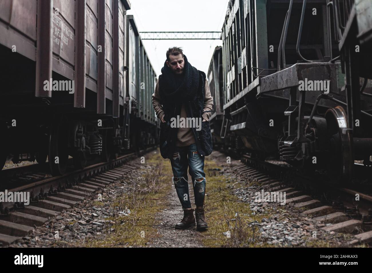Portrait of a man in the middle of trains Stock Photo - Alamy