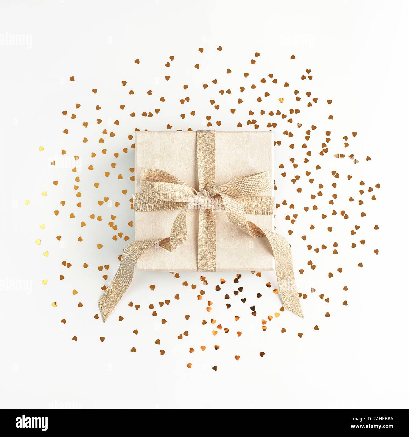 Beautiful present box with elegant golden bow on white background with ...