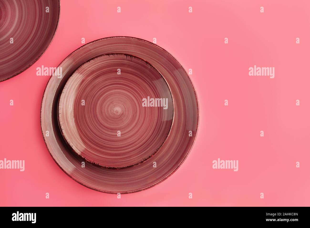Abstract trendy pink background with beautiful ceramic plates. Washing ...