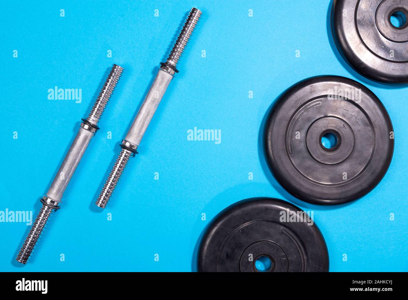 Fitness or bodybuilding. Sports equipment on a blue background, barbell ...