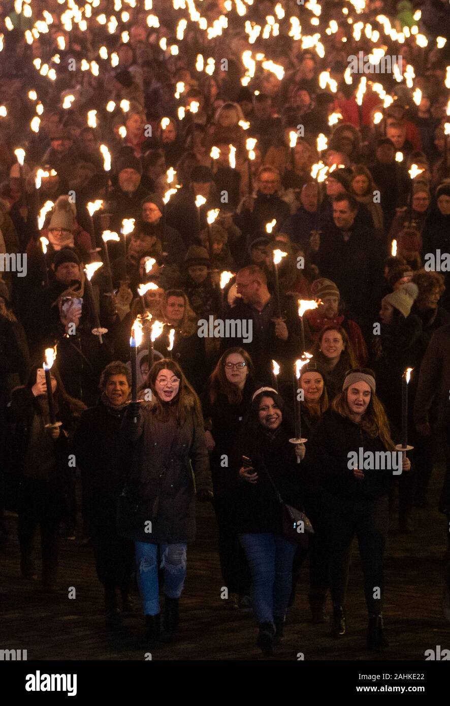 Members of the public take part in the annual torchlight procession as ...
