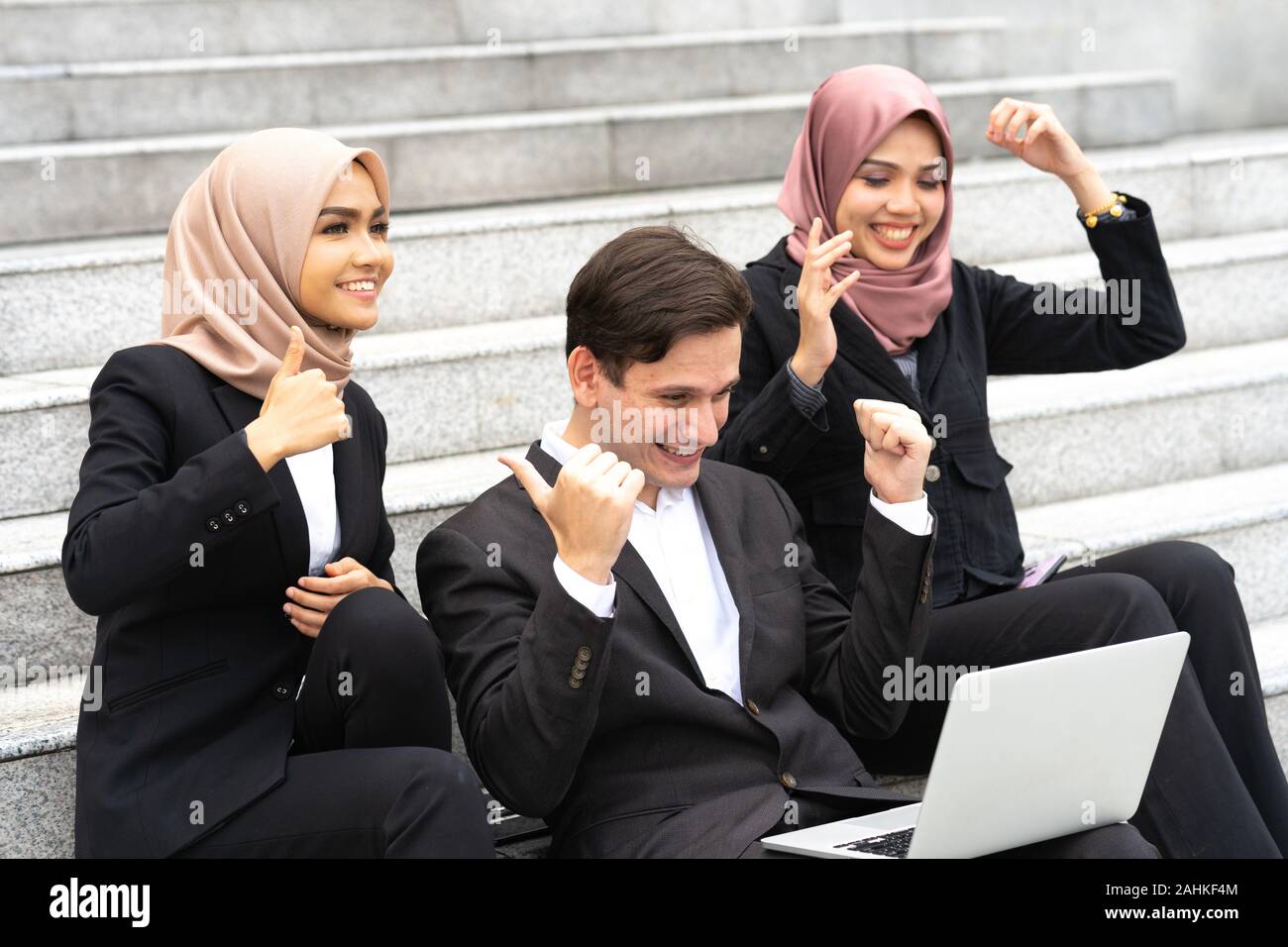 Group of business staff sit at staircase Stock Photo - Alamy