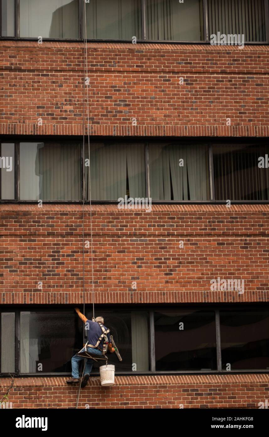 man washing windows on building in Springfield MA Stock Photo - Alamy