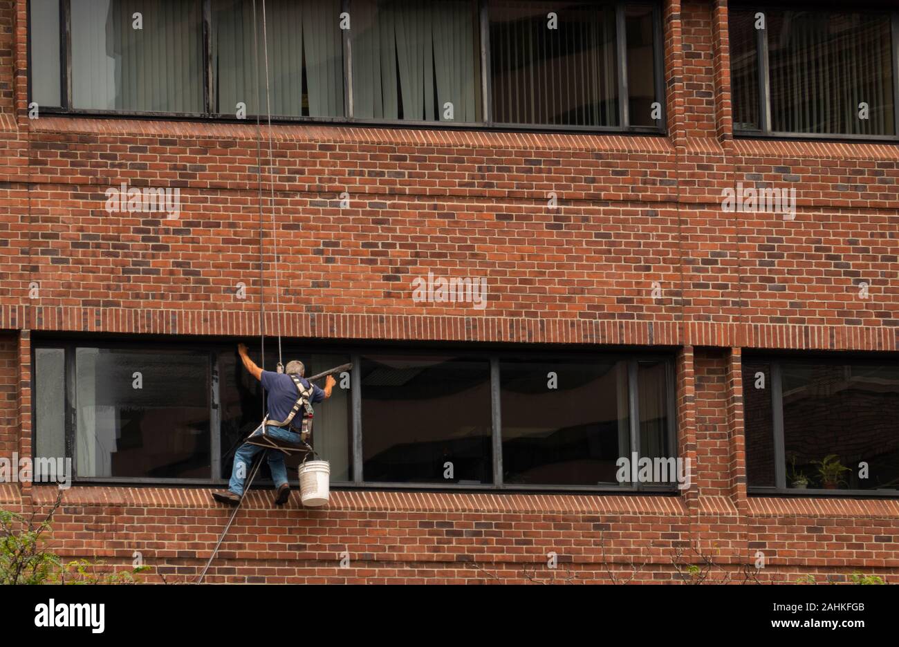 man washing windows on building in Springfield MA Stock Photo - Alamy