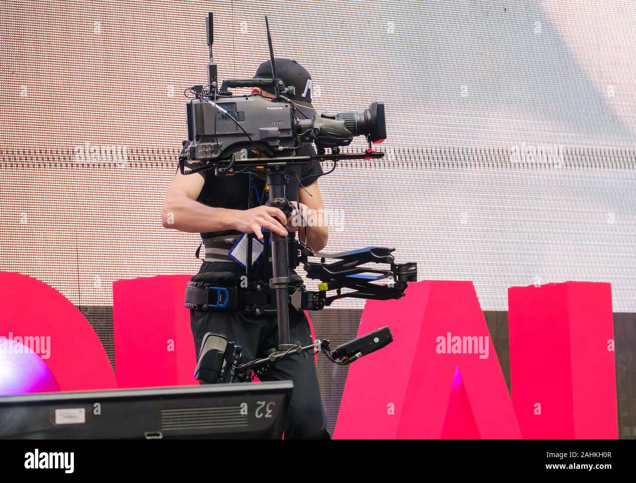 Steadicam camera man online broadcasting from stage Stock Photo - Alamy