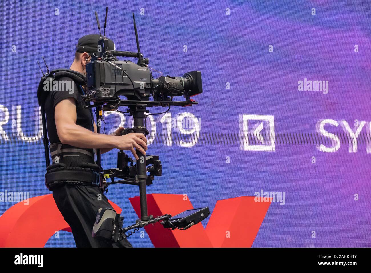 Steadicam camera man online broadcasting from stage Stock Photo - Alamy