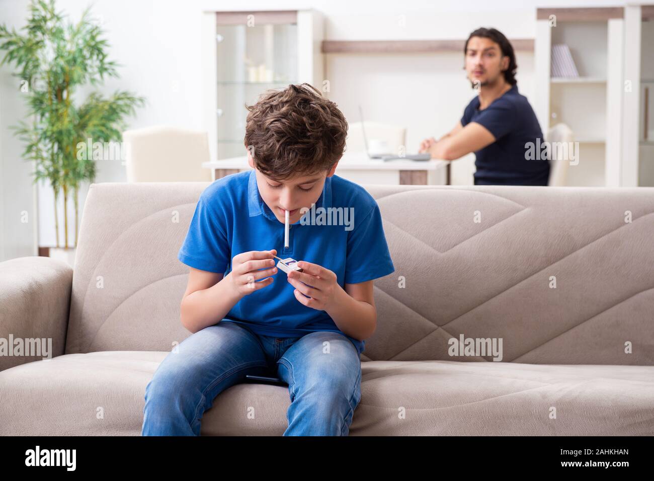 The concept of underage smoking with young boy and family Stock Photo ...