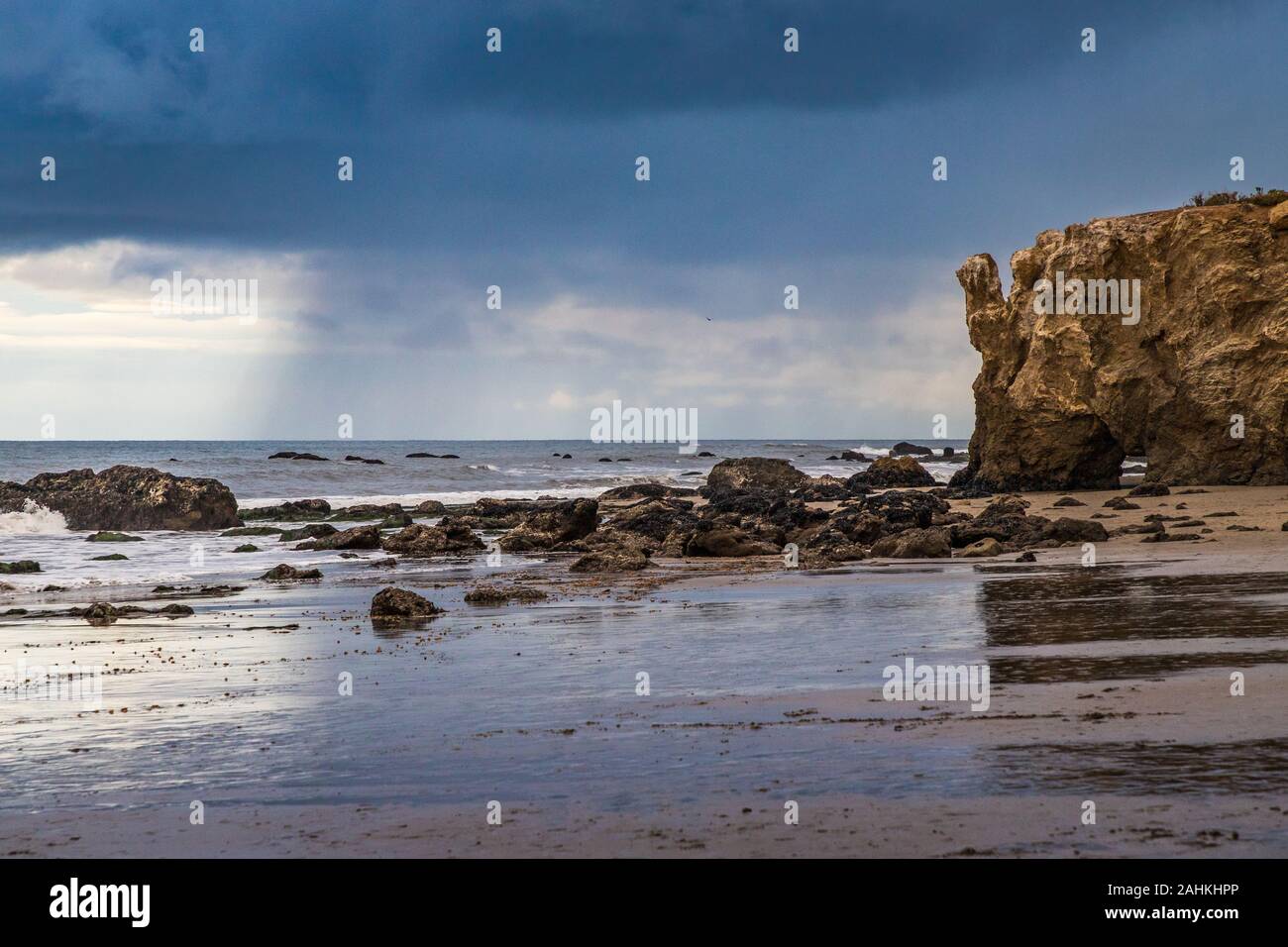 Coastline view of tall bluffs along El Matador Beach with reflections ...