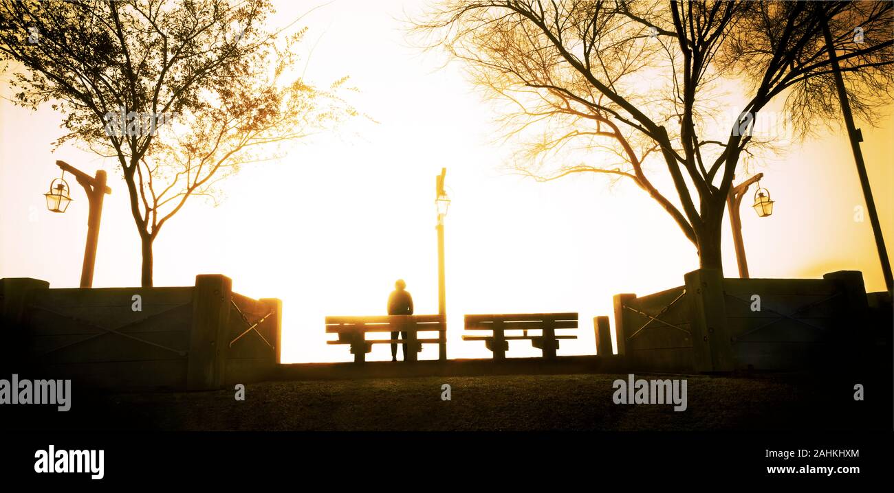 A person is standing next to a bench Stock Photo - Alamy