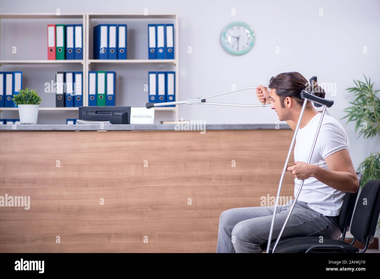Clinic reception counter and young patient Stock Photo - Alamy
