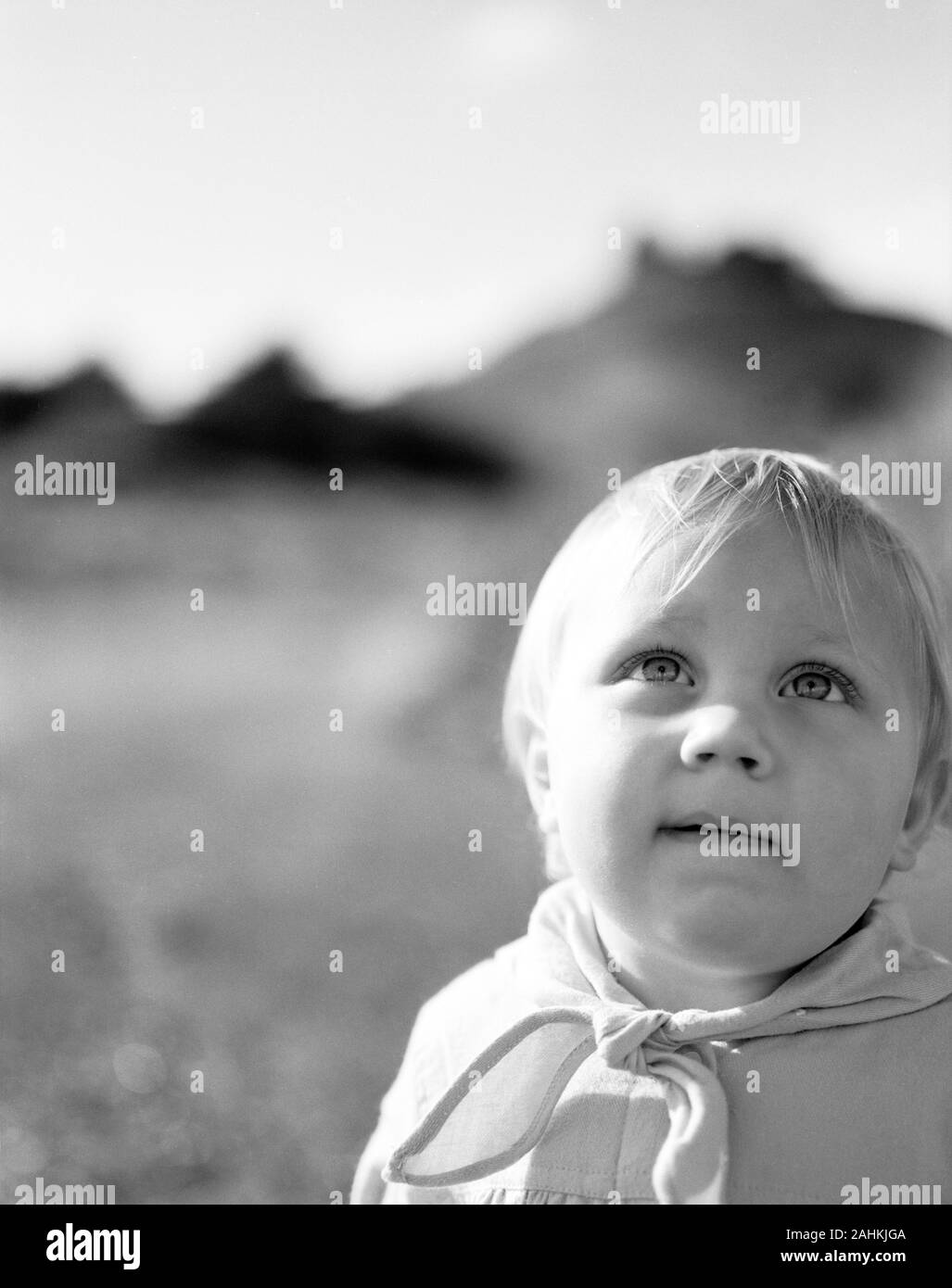 Cute toddler girl looking upwards Stock Photo - Alamy