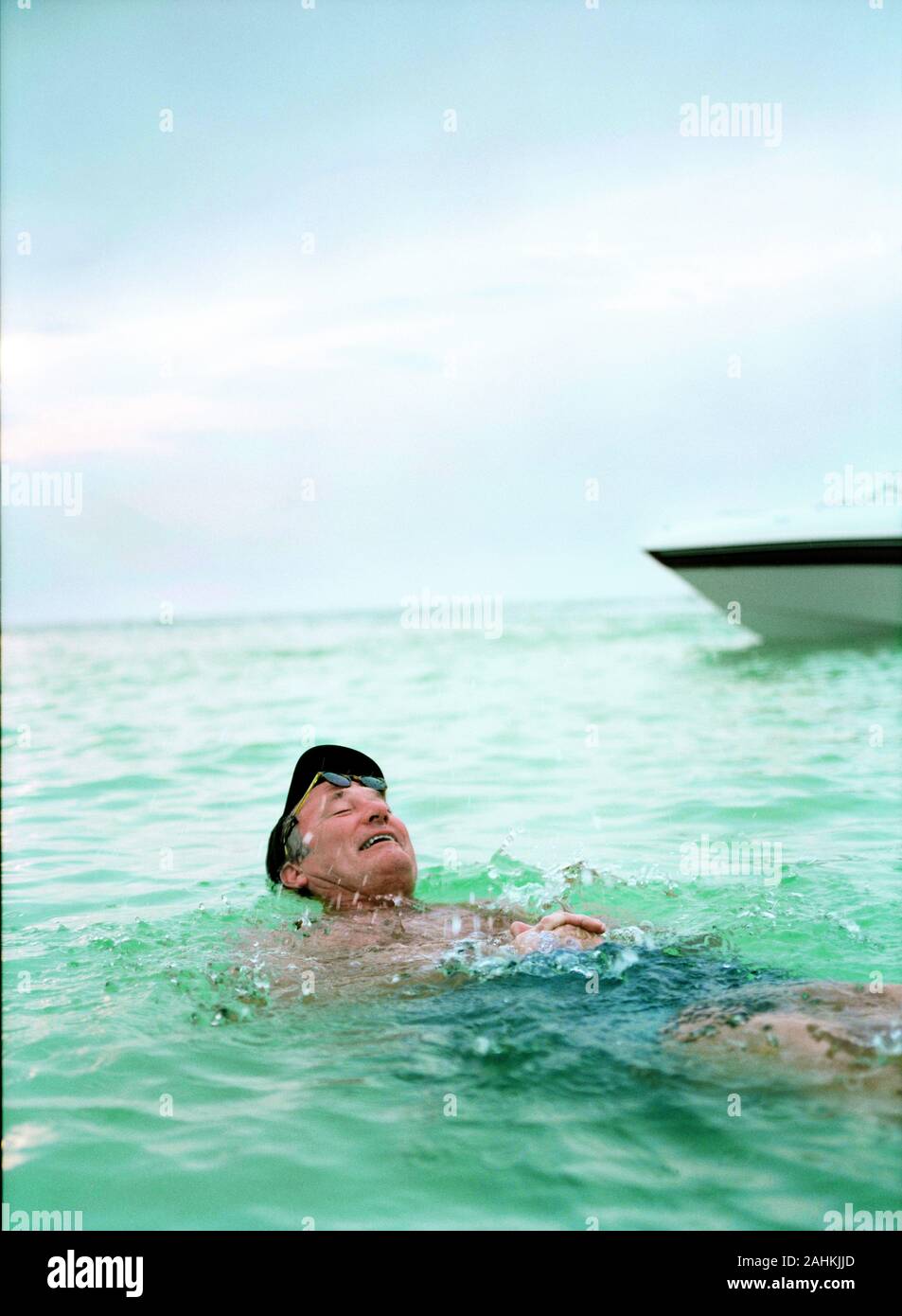 Man floating in sea vertical hi-res stock photography and images - Alamy
