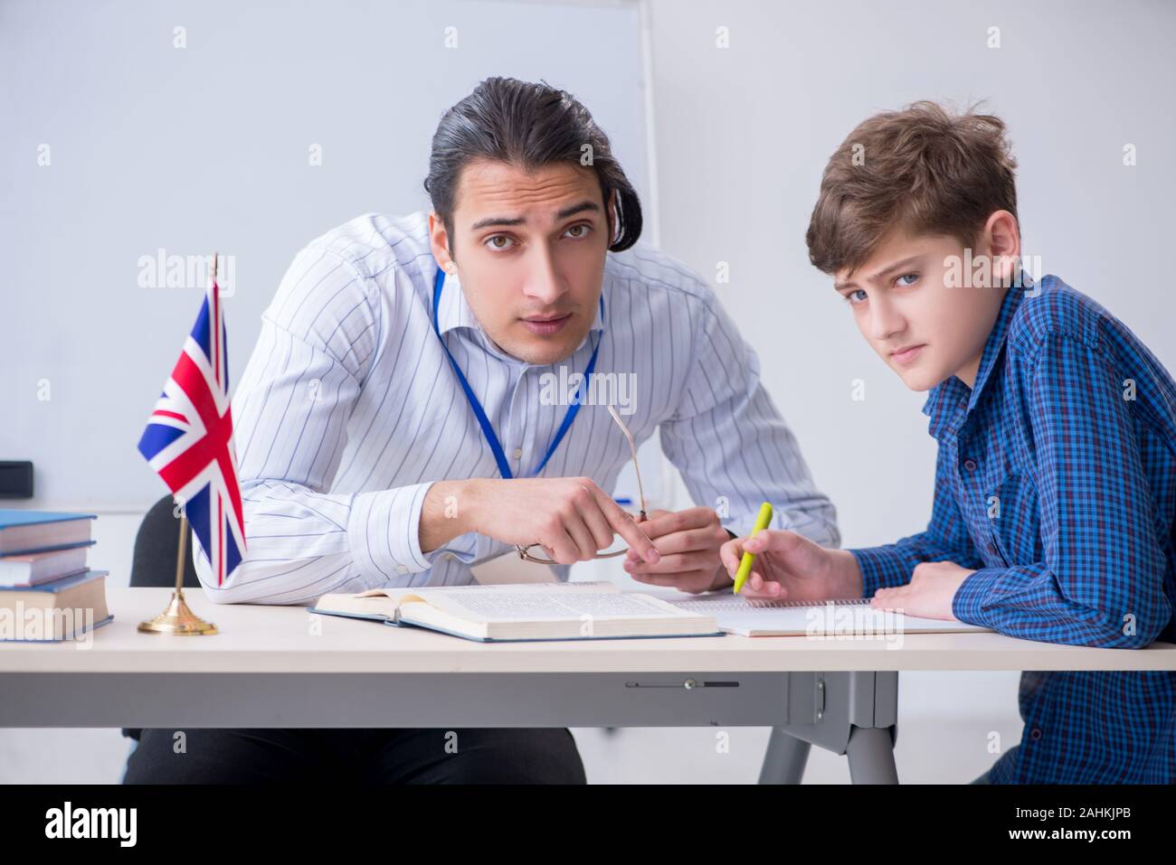 The male english teacher and boy in the classroom Stock Photo - Alamy